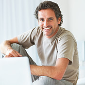 Happy man with laptop smiling | Buy Stock Photo on PeopleImages ...