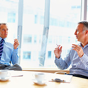 Executives having conversation at table | Buy Stock Photo on ...