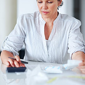 Busy female calculating taxes | Buy Stock Photo on PeopleImages ...