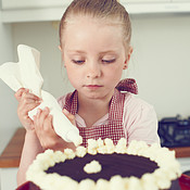 Carefully icing her first cake | Buy Stock Photo on PeopleImages ...
