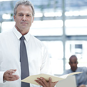 Reading a concise business file | Buy Stock Photo on PeopleImages ...