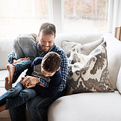 Roughhousing around with dad | Buy Stock Photo on PeopleImages, Picture ...
