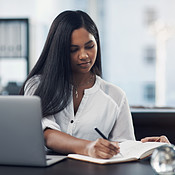 Ticking off tasks from her to-do list | Buy Stock Photo on PeopleImages ...