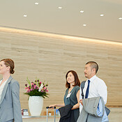 Business man and business woman meeting a concierge. Group of business ...