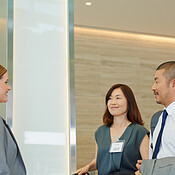Business man and business woman meeting a concierge. Group of business ...