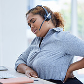 One young stressed mixed race female call centre telemarketing agent ...