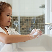 Little girl washing hands with water and soap in bathroom for diarrhea ...