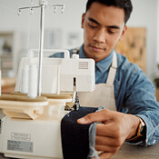 Fashion designer, young man and tailor in a creative workshop to sew ...