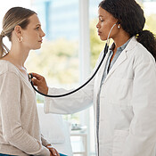 Doctor listening to patient breathing, heartbeat and lungs for ...