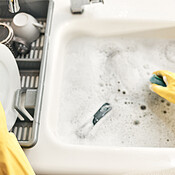 Housewife, maid or cleaner hands washing dishes in the kitchen sink for ...