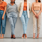 Feet and legs of team of business women standing together, doing ...