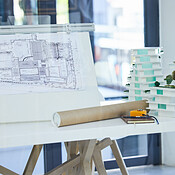 Architecture, design and blueprints on an office desk with plans and a ...