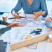 Blueprints, architects and building engineers talking, meeting and ...