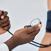 Blood pressure or hypertension test by a healthcare professional on a ...