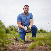 Farmer planting, growing and holding crops, plant and agriculture in ...