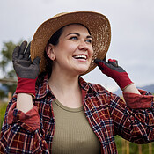 Happy, rustic female farmer checking weather for outdoor farming ...