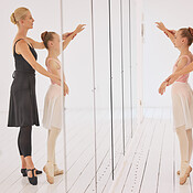 Ballet education, teacher and girl dancer learning on mirror from her ...