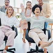 Happy corporate colleagues having fun and being playful in an office ...