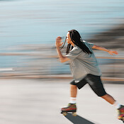 Fitness, exercise and a man on roller skates moving fast with blurred ...