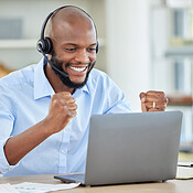 Success, winner or black call center man with laptop in customer ...