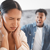 Woman scared, noise and abuse from angry man in the living room at home ...