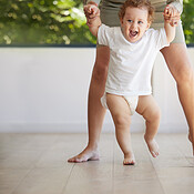 Baby boy, learning and walking with mom in support, first steps and ...