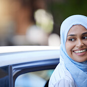 Muslim business woman using car to travel for transport in urban city ...