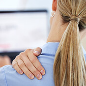 Receptionist with neck pain, burnout and stress working on a laptop in ...