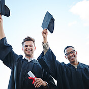 Graduation, education and students with blue sky happy with success in ...