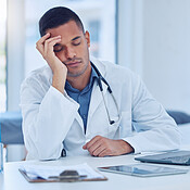 Tired man in medical hospital, doctor napping at office desk and ...