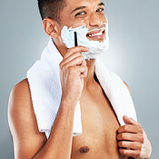 Man shaving face, razor and shower for hair removal, aesthetic skincare and facial cleaning on ...