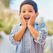 Portrait, smile and surprised happy boy in nature, outdoors or smiling ...