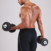 Man, working out muscle and dumbell in studio for strength training ...