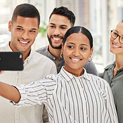 Business people taking team selfie for social media on smartphone ...