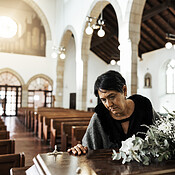 Widow, coffin and sad at a funeral feeling depression from death ...