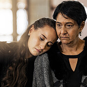 Sad, empathy and funeral with women in church for mourning, grief and ...