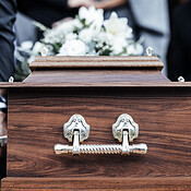 Coffin, people and funeral with death, grief and service with family ...