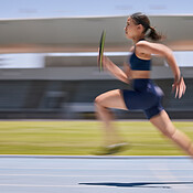 Fitness, speed and runner, woman running relay race with athlete and ...