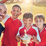 Soccer, football team and coach winning trophy from competition game ...