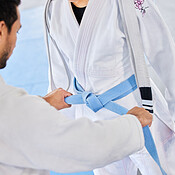 Karate, blue belt and teacher with student, fitness and taekwondo ...