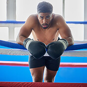 Boxing ring, man and tired from fight, training and workout in gym ...