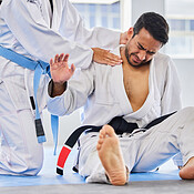 Karate, sports and neck injury pain of fighter on floor with surrender ...