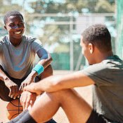 Basketball, sport and athlete friends talk after training, exercise and ...