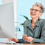 Happy senior, executive woman and computer at office desk, smile and ...