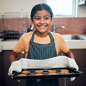 Baking, cookies and children with an indian girl cooking baked goods in ...