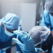 Doctors, nurses or hands with surgery needle in anesthesia treatment ...