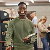 Black man, book and portrait in library with smile, research and ...