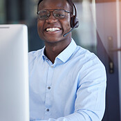 Black man, call center and portrait by computer with smile, typing and ...