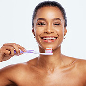 Portrait, dental and a black woman brushing teeth in studio isolated on ...