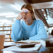 Woman student, fatigue with headache and university burnout, stress for ...